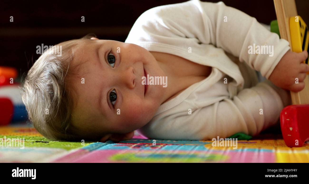 Baby hands holding play toy, close-up infant plays with child ...