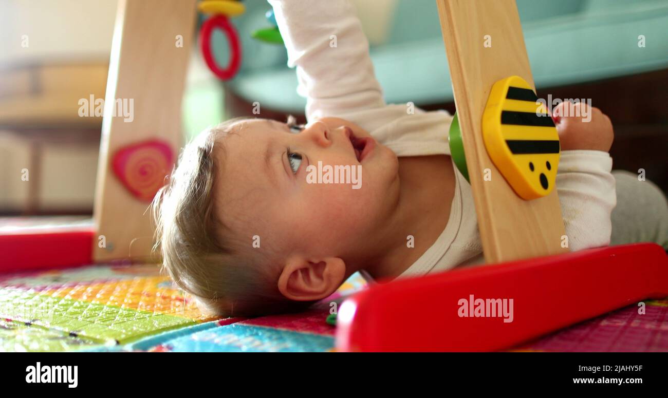 Baby hands holding play toy, close-up infant plays with child ...