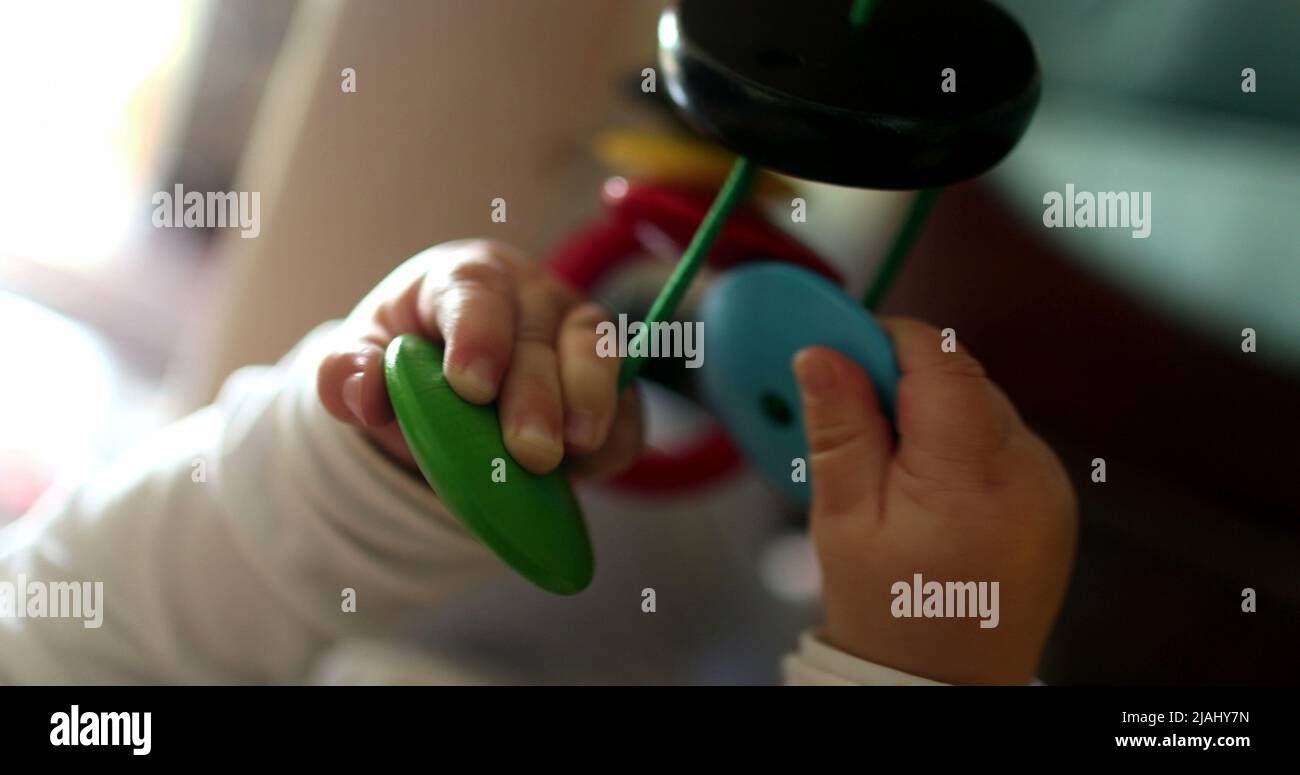 Baby hands touching hanging toy, close-up infant hand toys activity ...