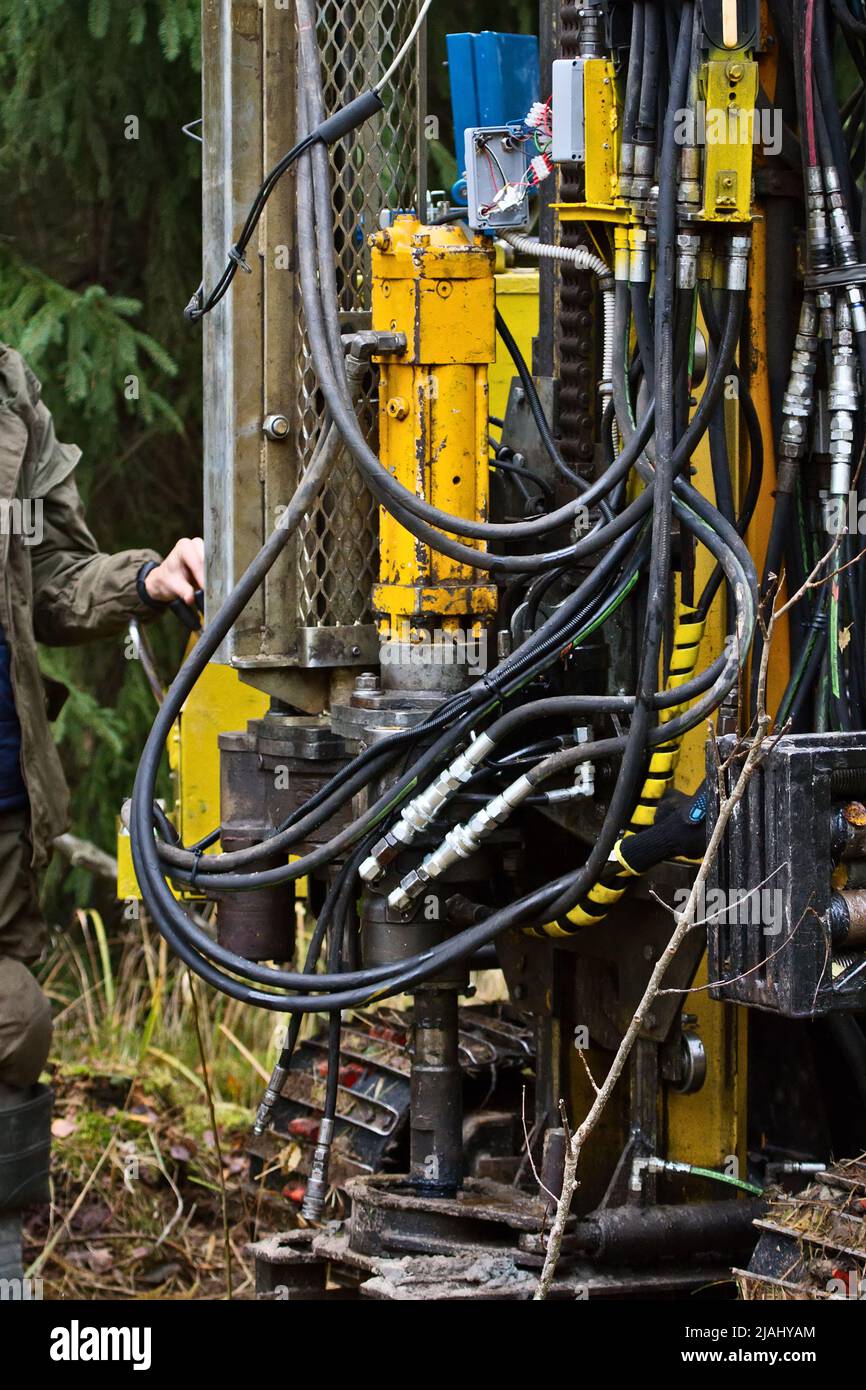 Self-propelled Mini-drilling rig drills the soil in forest conditions ...