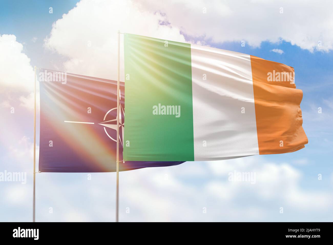Sunny blue sky and flags of ireland and nato Stock Photo - Alamy