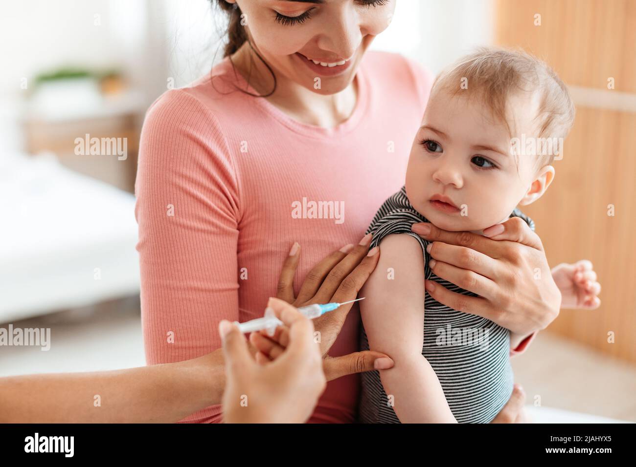 Vaccination concept. Pediatrician doctor giving vaccine shot to little ...