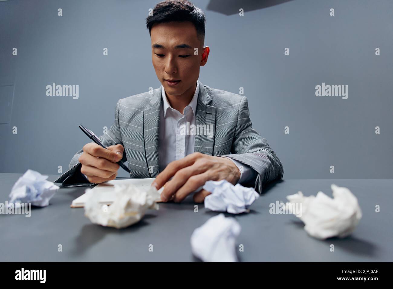 Asian man sits in the office emotions nervous breakdown anger isolated ...