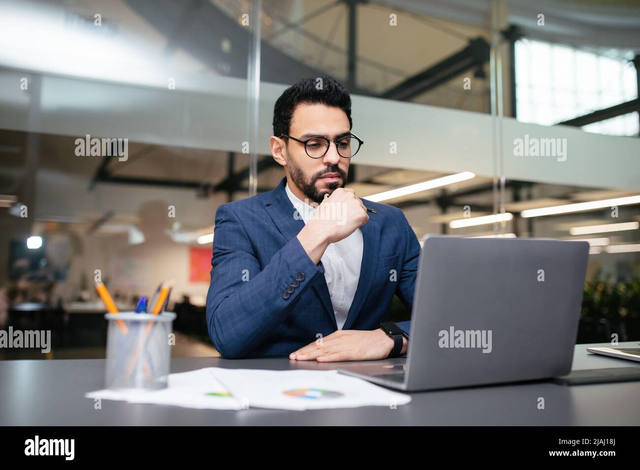 Smart pensive handsome young middle eastern businessman with beard in ...