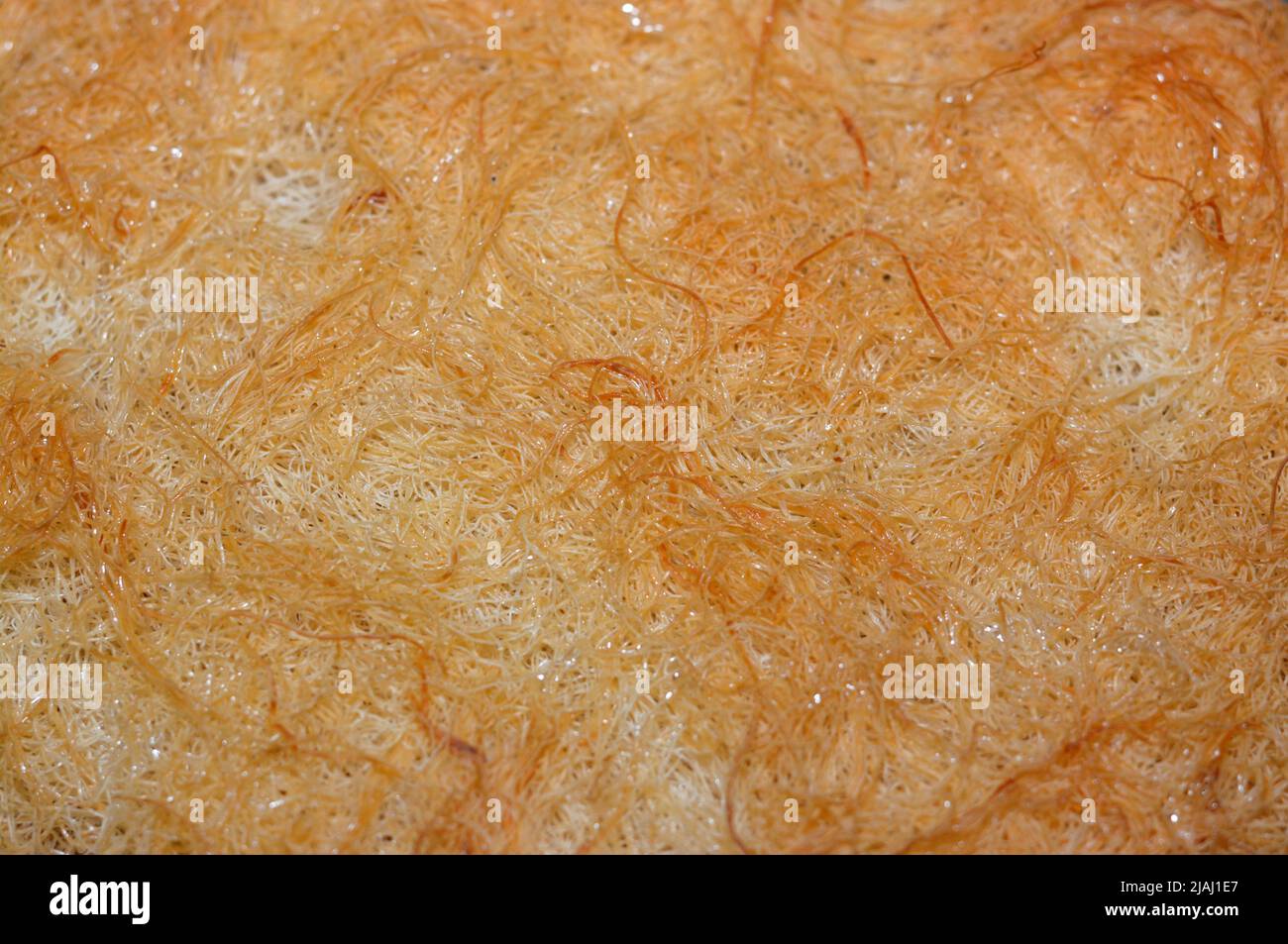 A traditional middle eastern dessert Knafeh made with spun pastry ...
