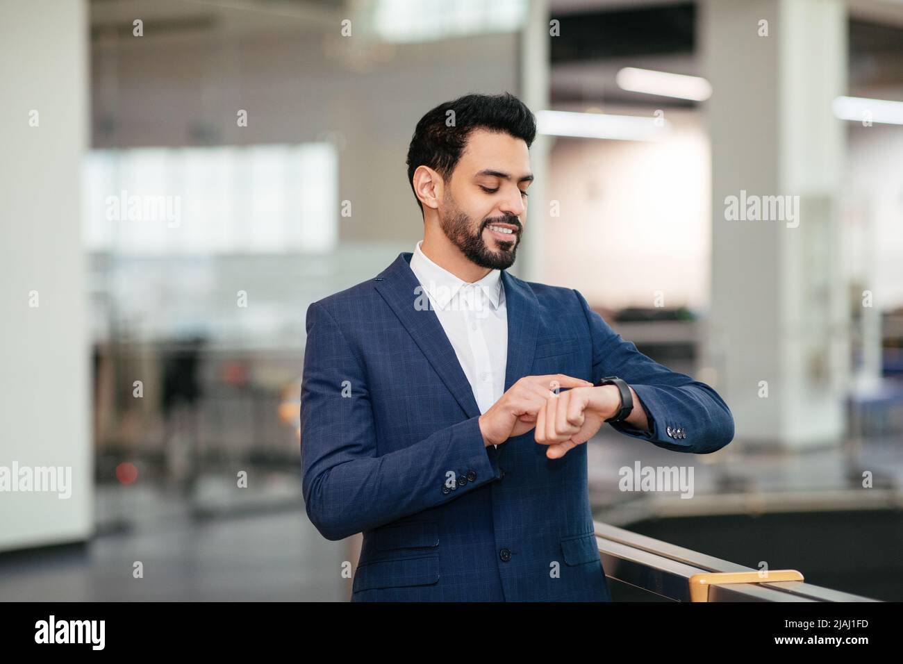 Happy confident young islamic ceo manager with beard in suit looks at ...