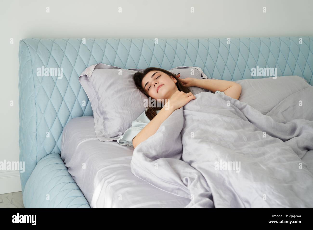 Beautiful woman sleeping in comfort bed. Rest, bed linen. Apartment ...