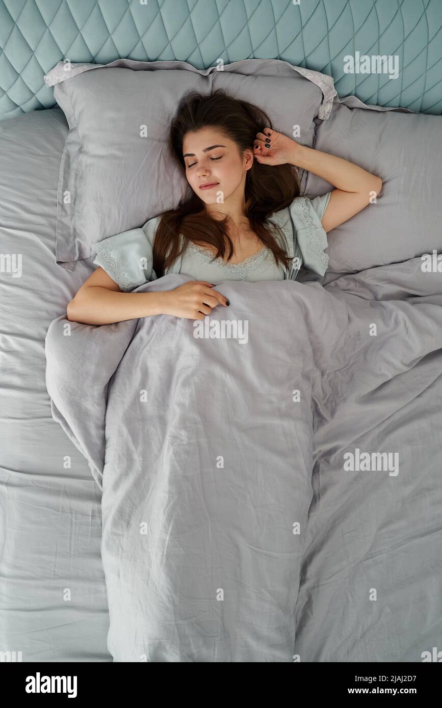 Beautiful woman sleeping in comfort bed. Rest, bed linen. Apartment ...