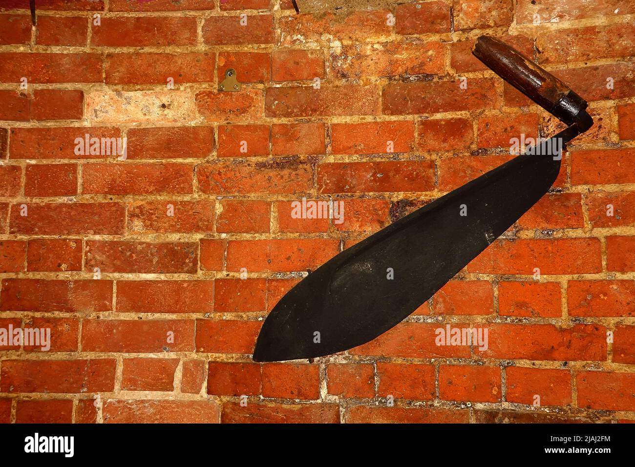 An old hand Scythe set against a brick wall Stock Photo - Alamy