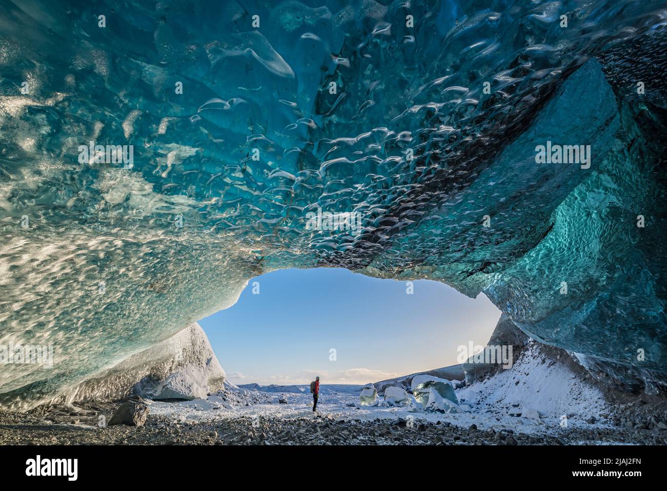 View looking out from inside a deep ice cave underneath a glacier in ...