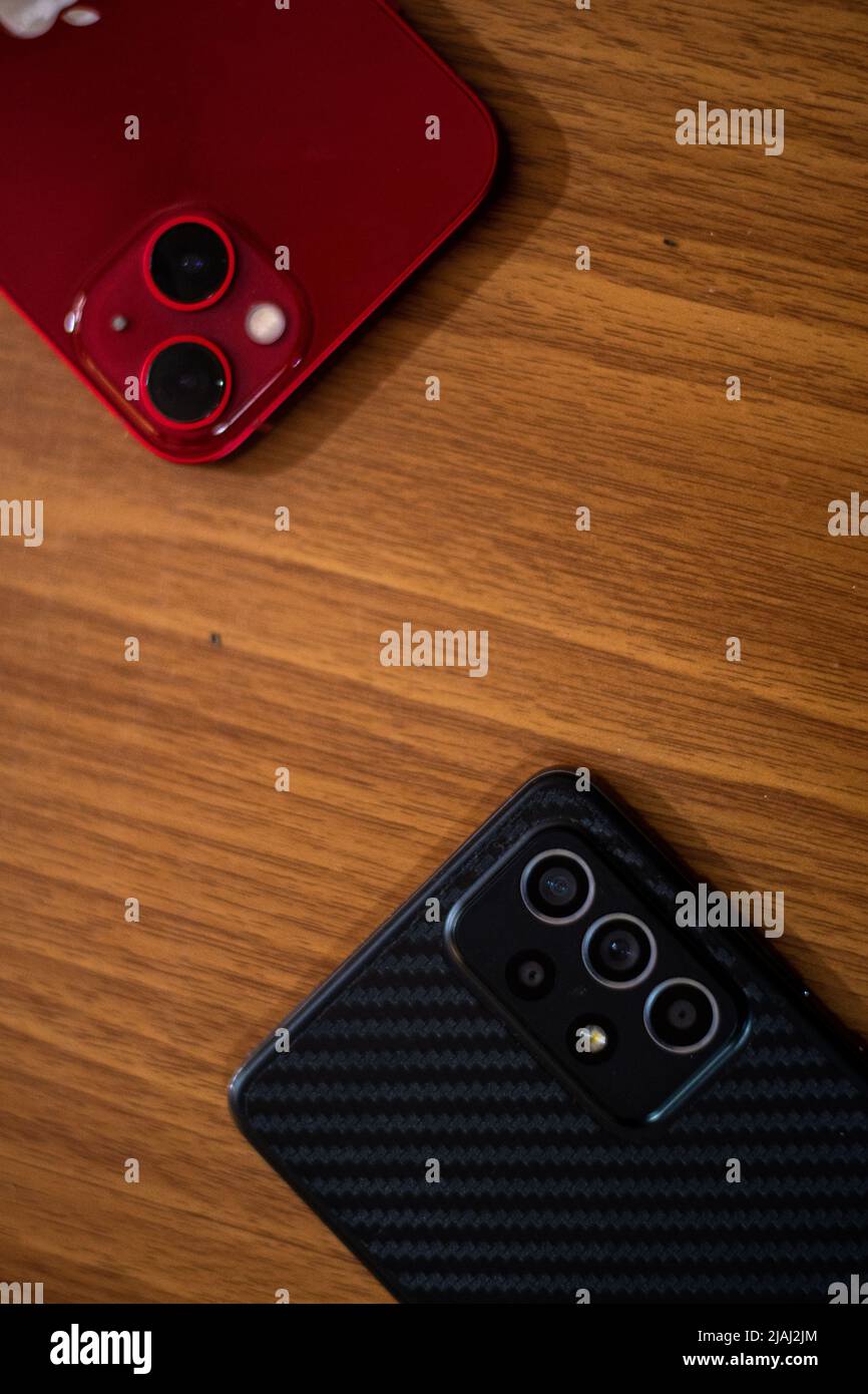 Two brands of mobile phones on a table Stock Photo - Alamy