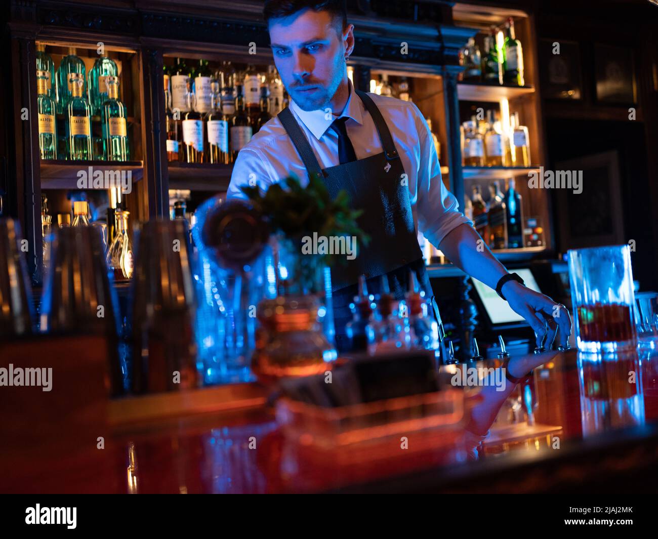 Bartender behind counter at bar hi-res stock photography and images - Alamy
