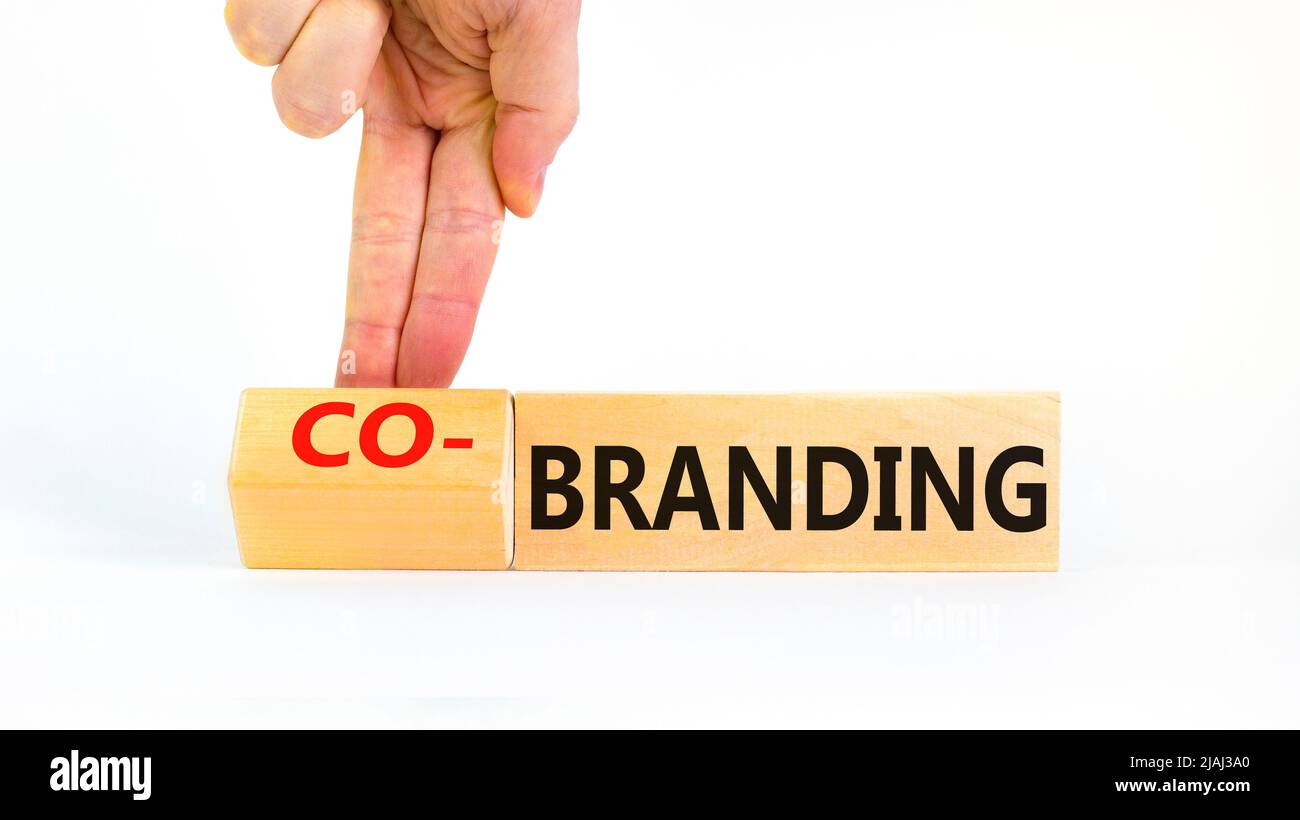 Branding or co-branding symbol. Businessman turns wooden cubes and ...