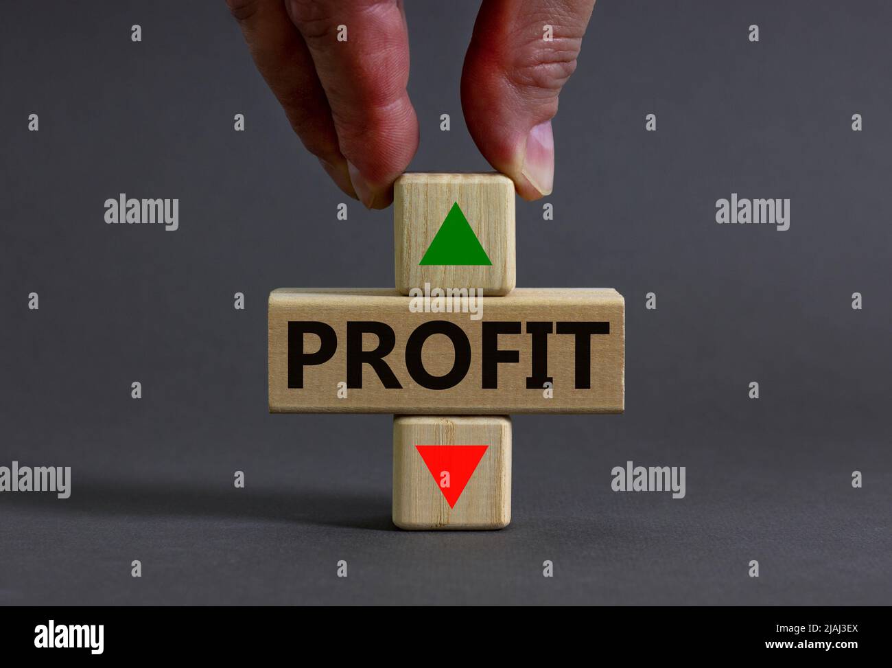 Profit level symbol. Businessman holds a wooden cube with up icon ...