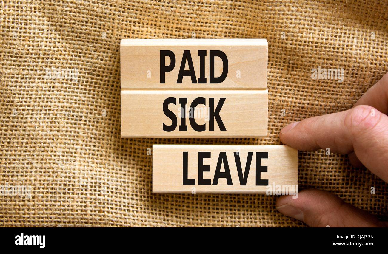 Paid sick leave symbol. Concept words Paid sick leave on wooden blocks ...