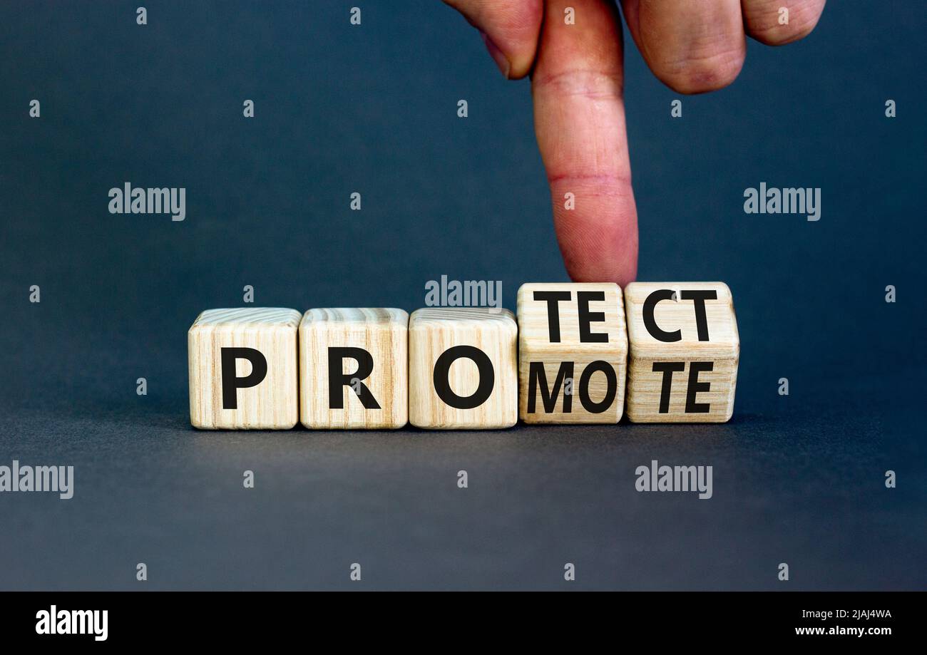 Promote or protect symbol. Businessman turns wooden cubes and changes ...