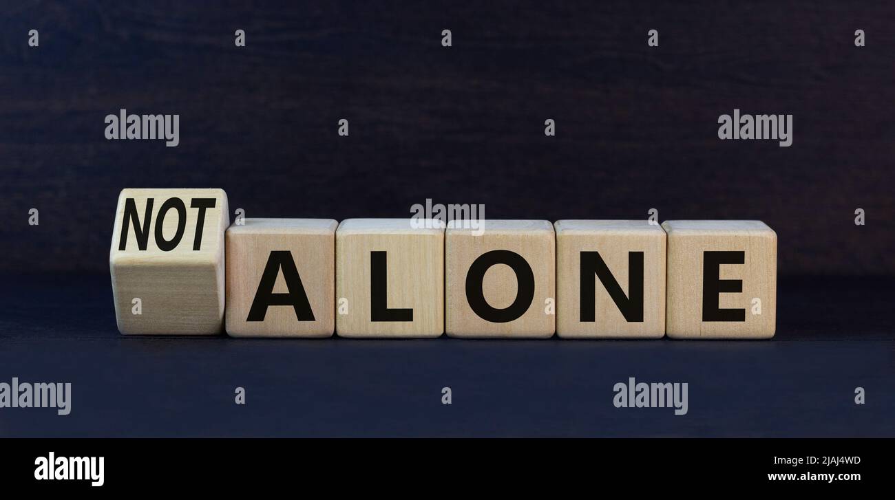 You are not alone symbol. Turned wooden cubes and changed concept words ...