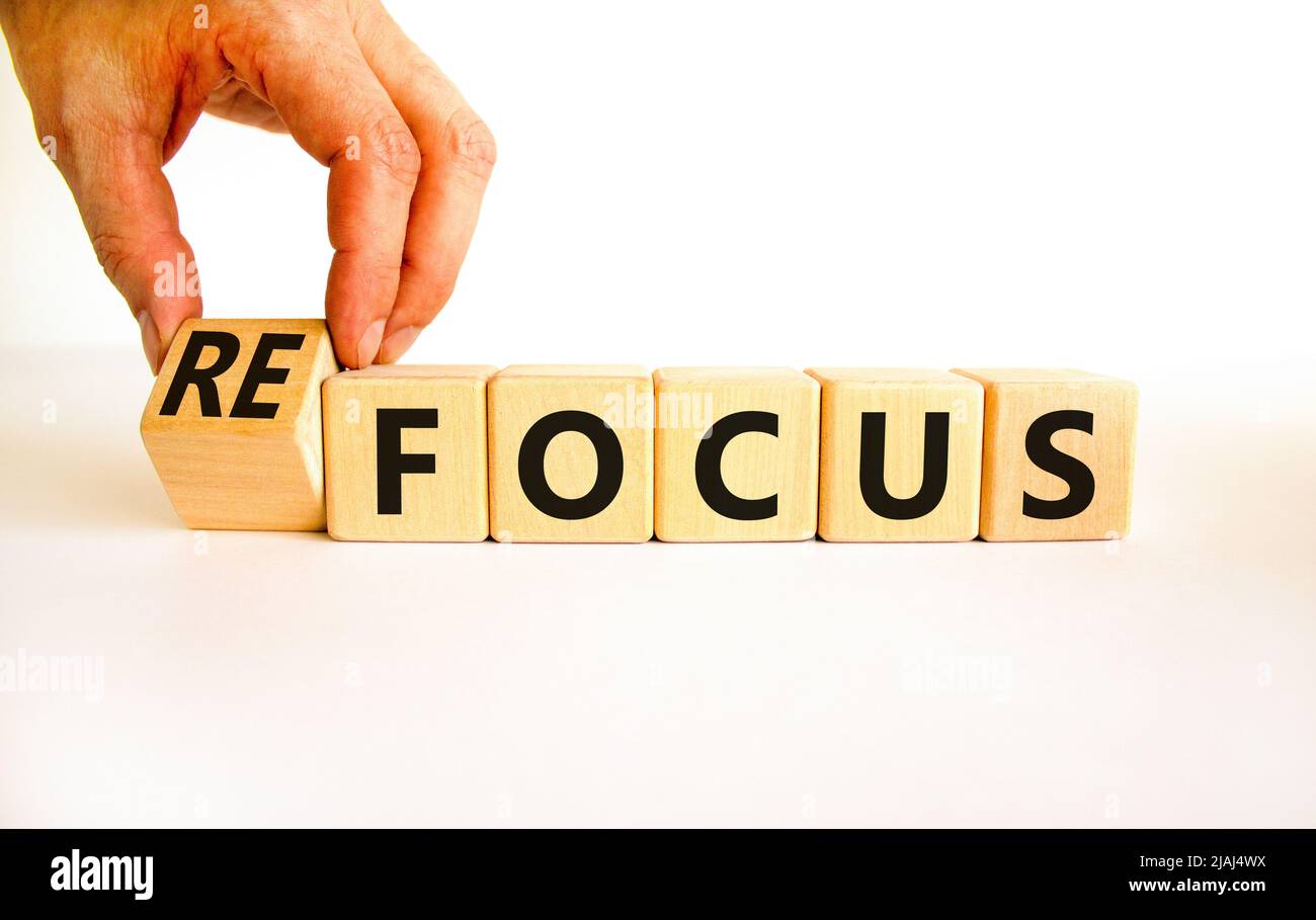 Focus or refocus symbol. Businessman turns wooden cubes and changes the ...