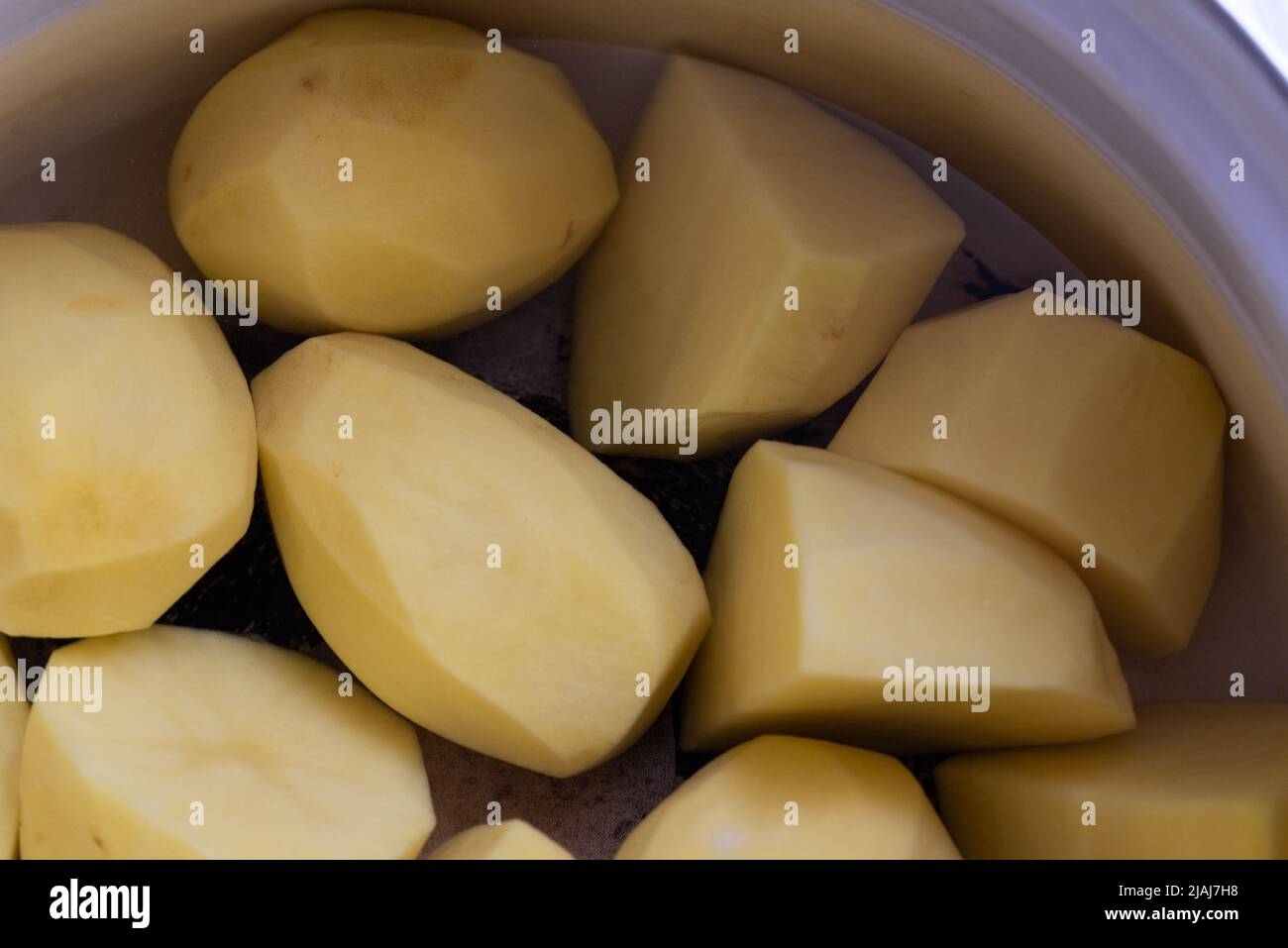 Peeled potatoes in cold water. Peeled potatoes for cooking. Potato ...