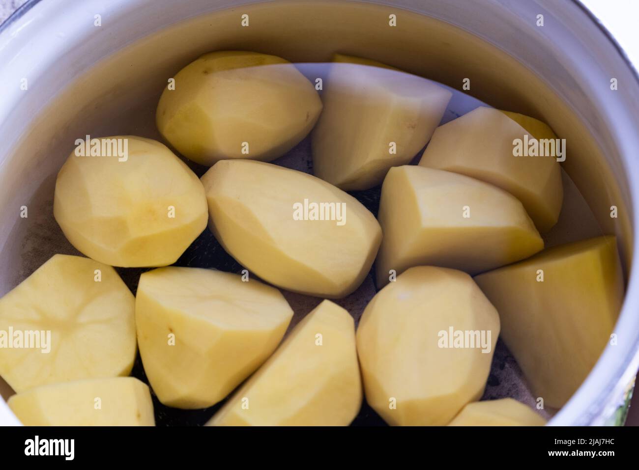 Peeled potatoes in cold water. Peeled potatoes for cooking. Potato ...