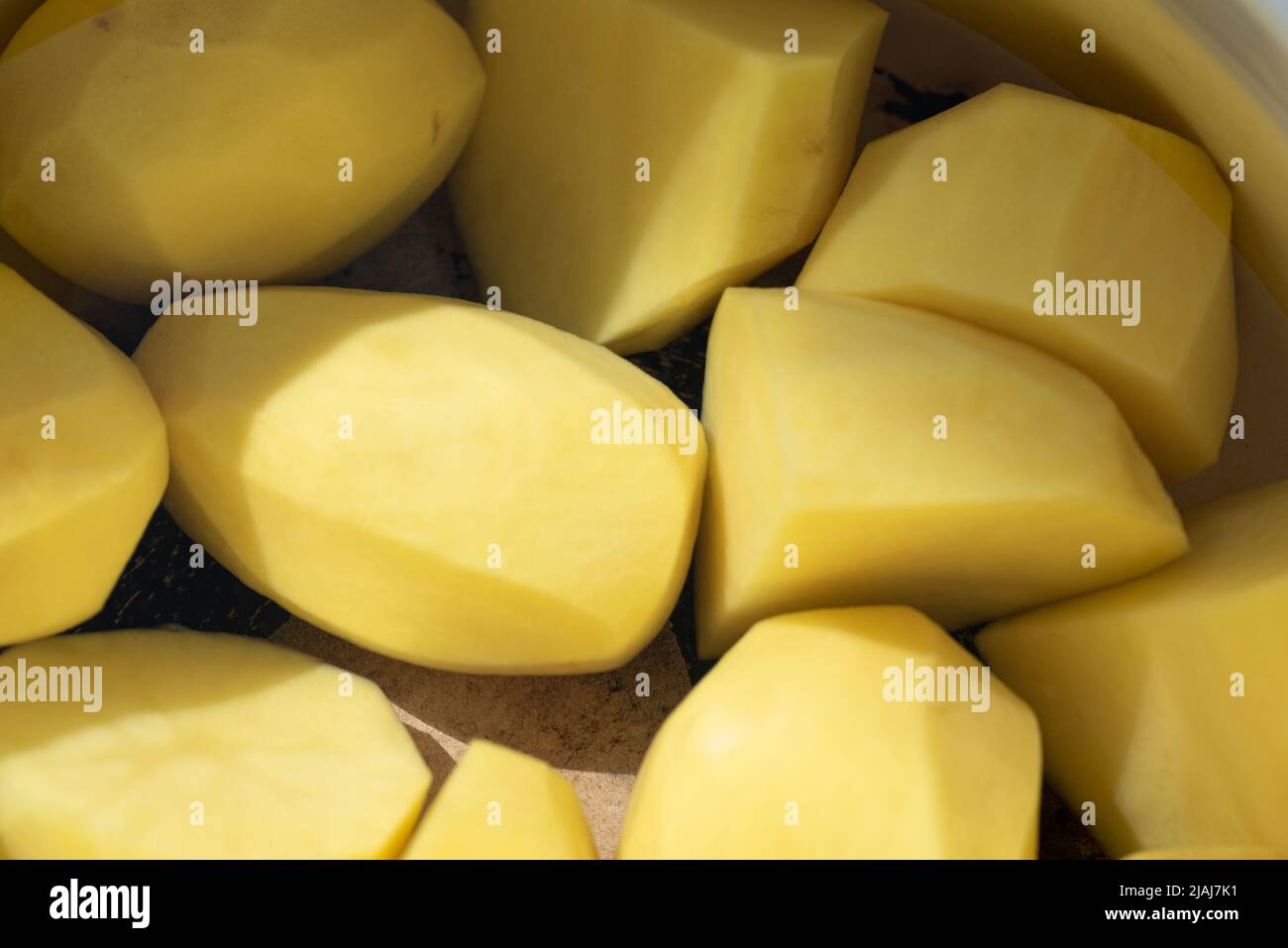 Peeled potatoes in cold water. Peeled potatoes for cooking. Potato ...