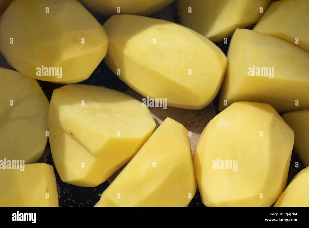 Peeled potatoes in cold water. Peeled potatoes for cooking. Potato ...