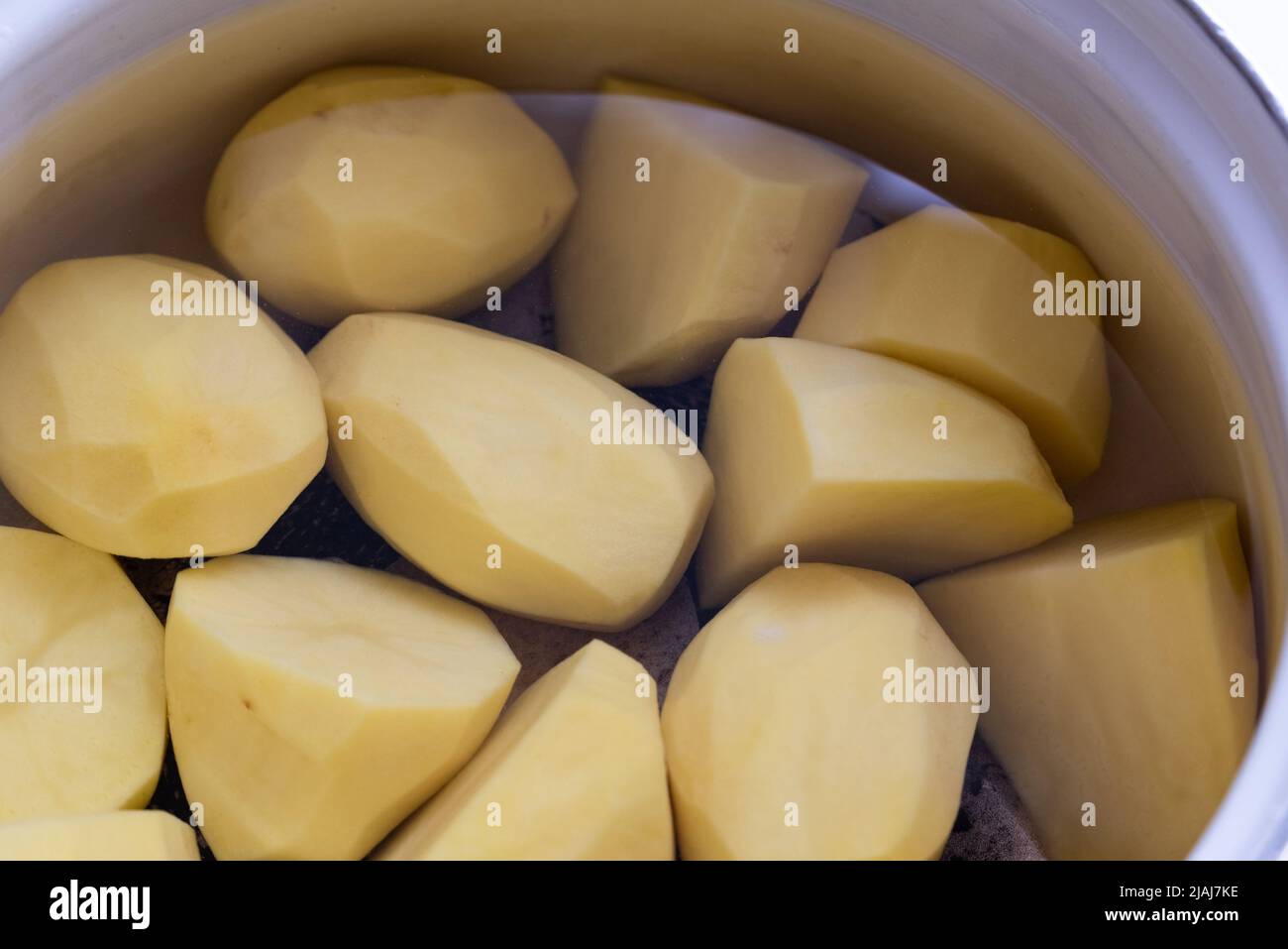 Peeled potatoes in cold water. Peeled potatoes for cooking. Potato ...