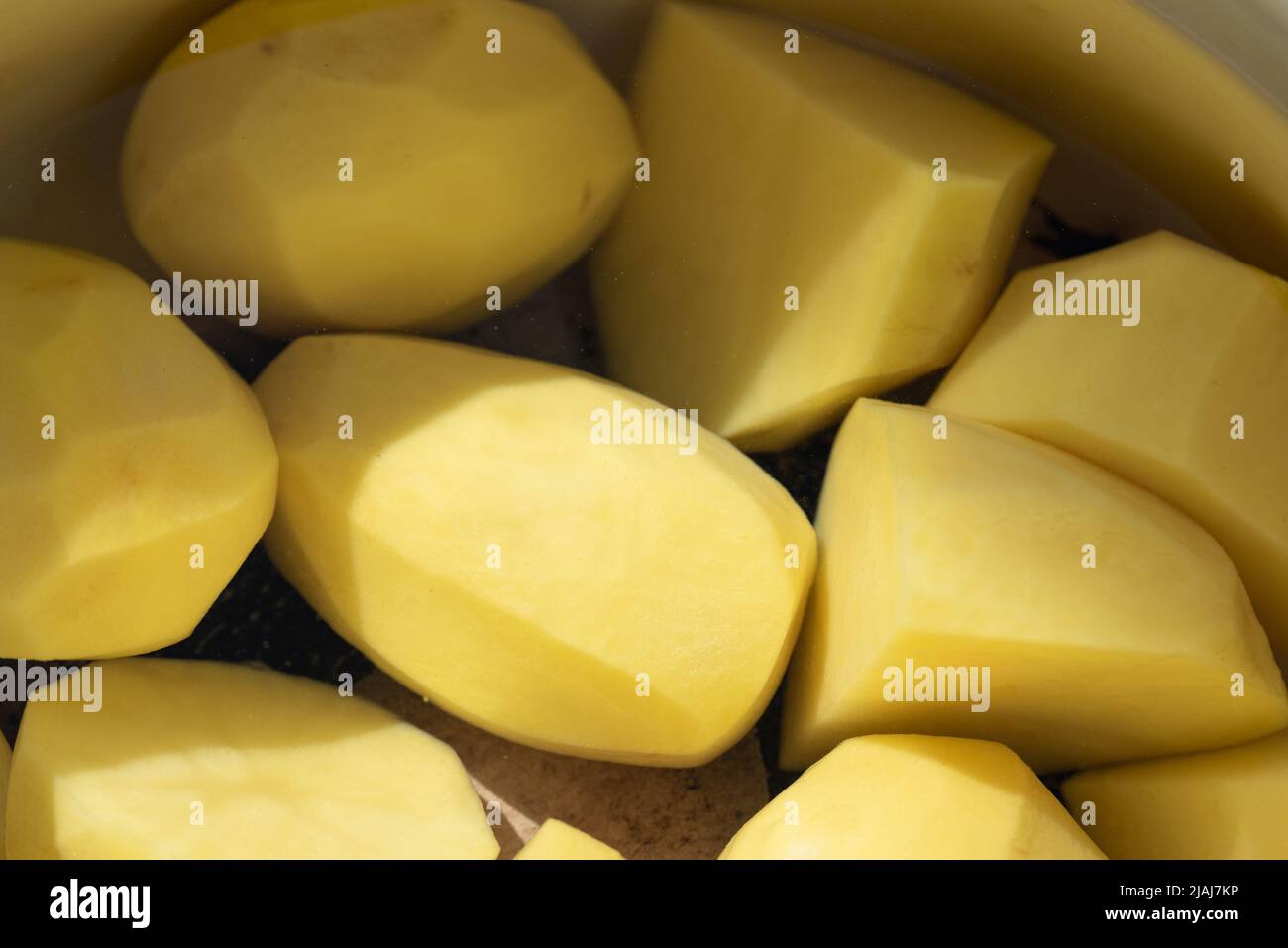 Peeled potatoes in cold water. Peeled potatoes for cooking. Potato ...