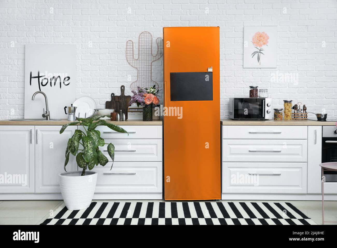 Stylish interior of modern kitchen with big orange refrigerator Stock ...