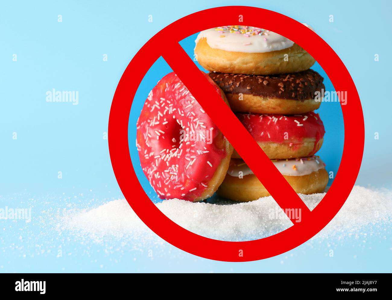 Sweet donuts and prohibition sign on light blue background. No sugar ...