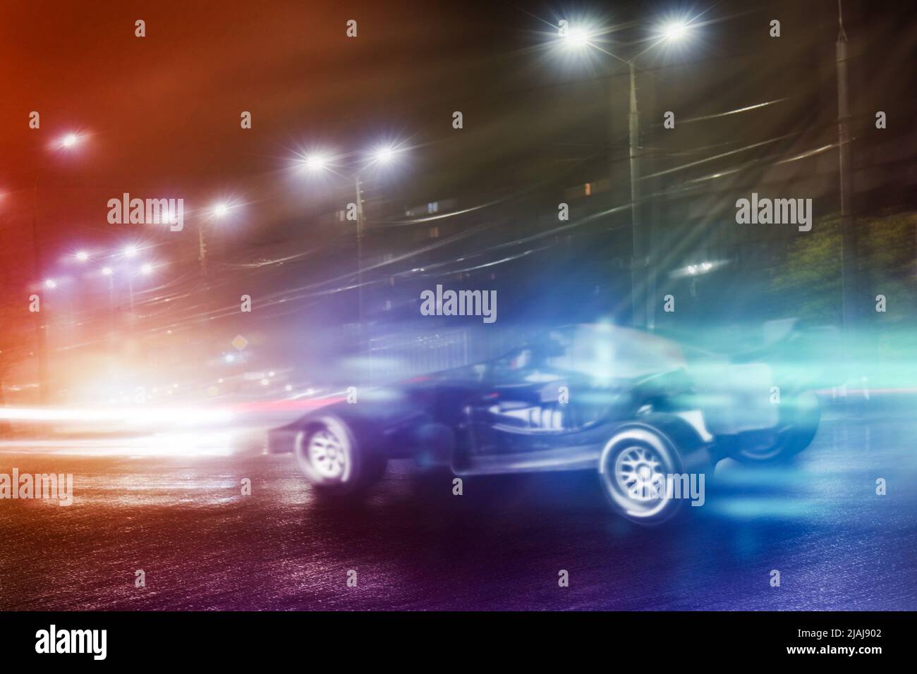 Fast racing car on night city street Stock Photo - Alamy