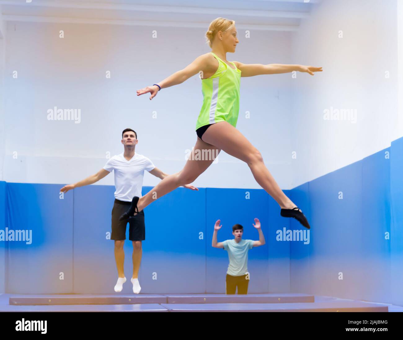 Female gymnast jumping on trampoline Stock Photo - Alamy