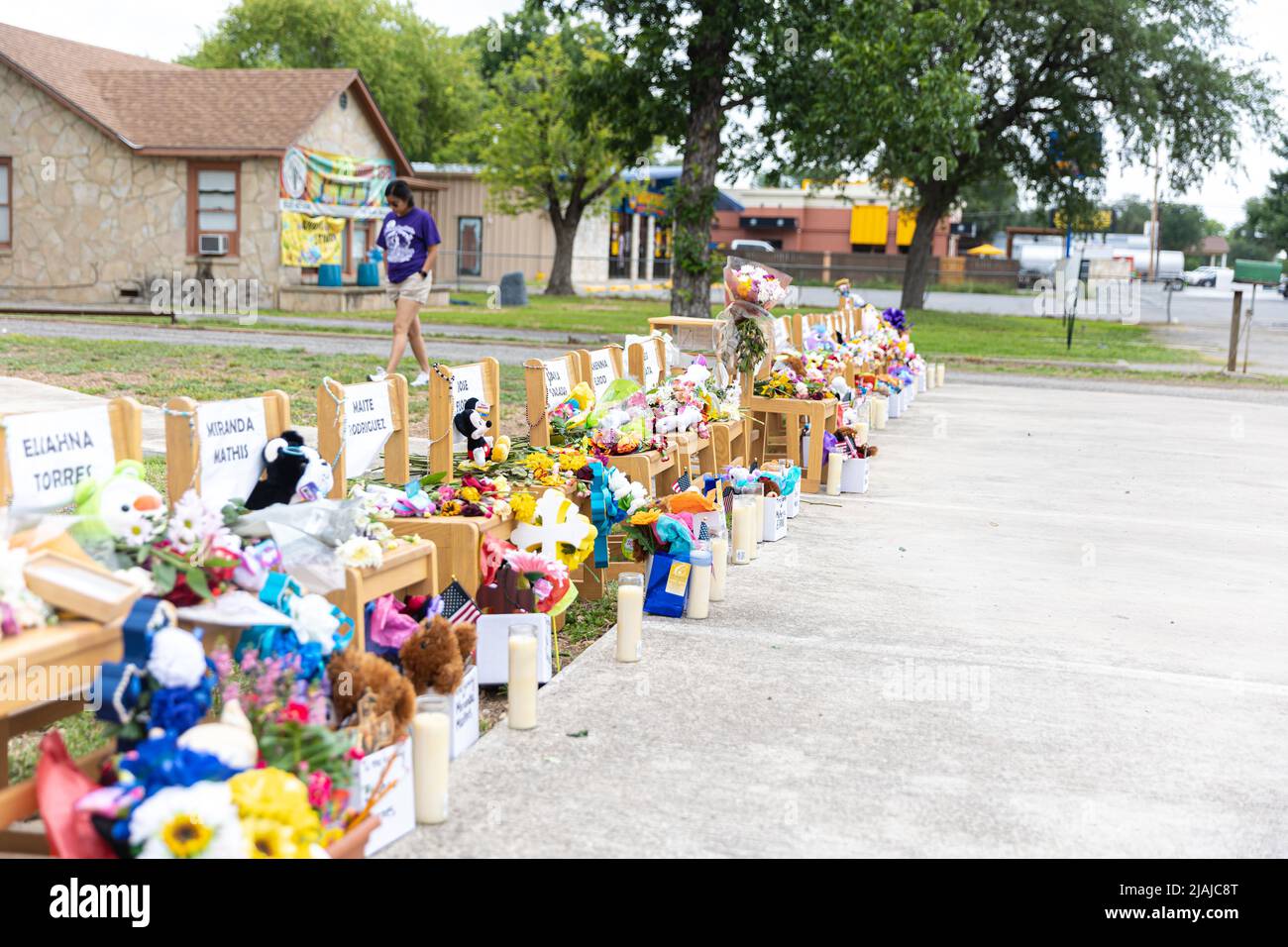 Uvalde, TX. May 30th, 2022, 21 chairs, flags and crosses are displayed ...