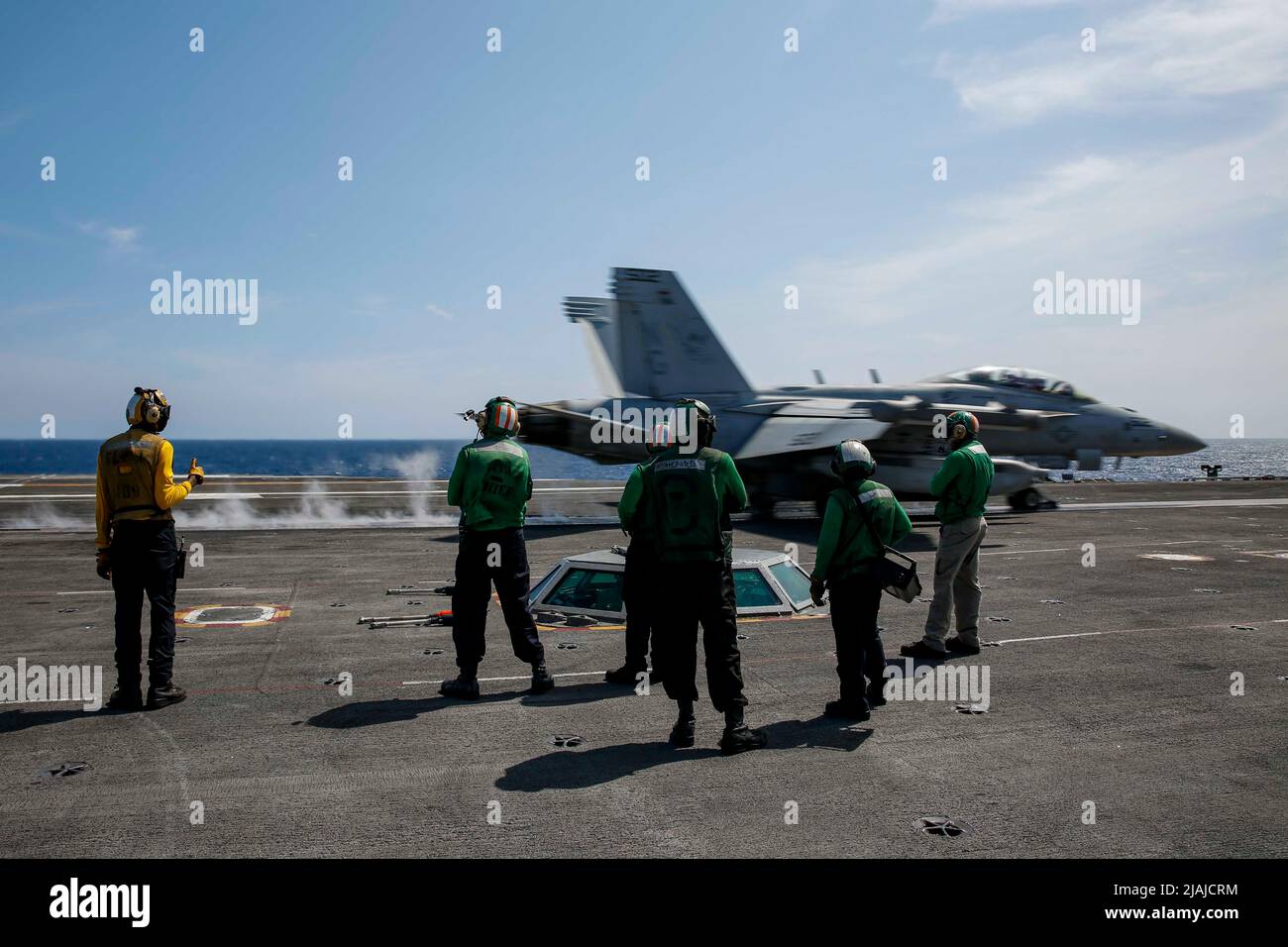 PHILIPPINE SEA (May 27, 2022) Sailors observe an EA-18G Growler ...