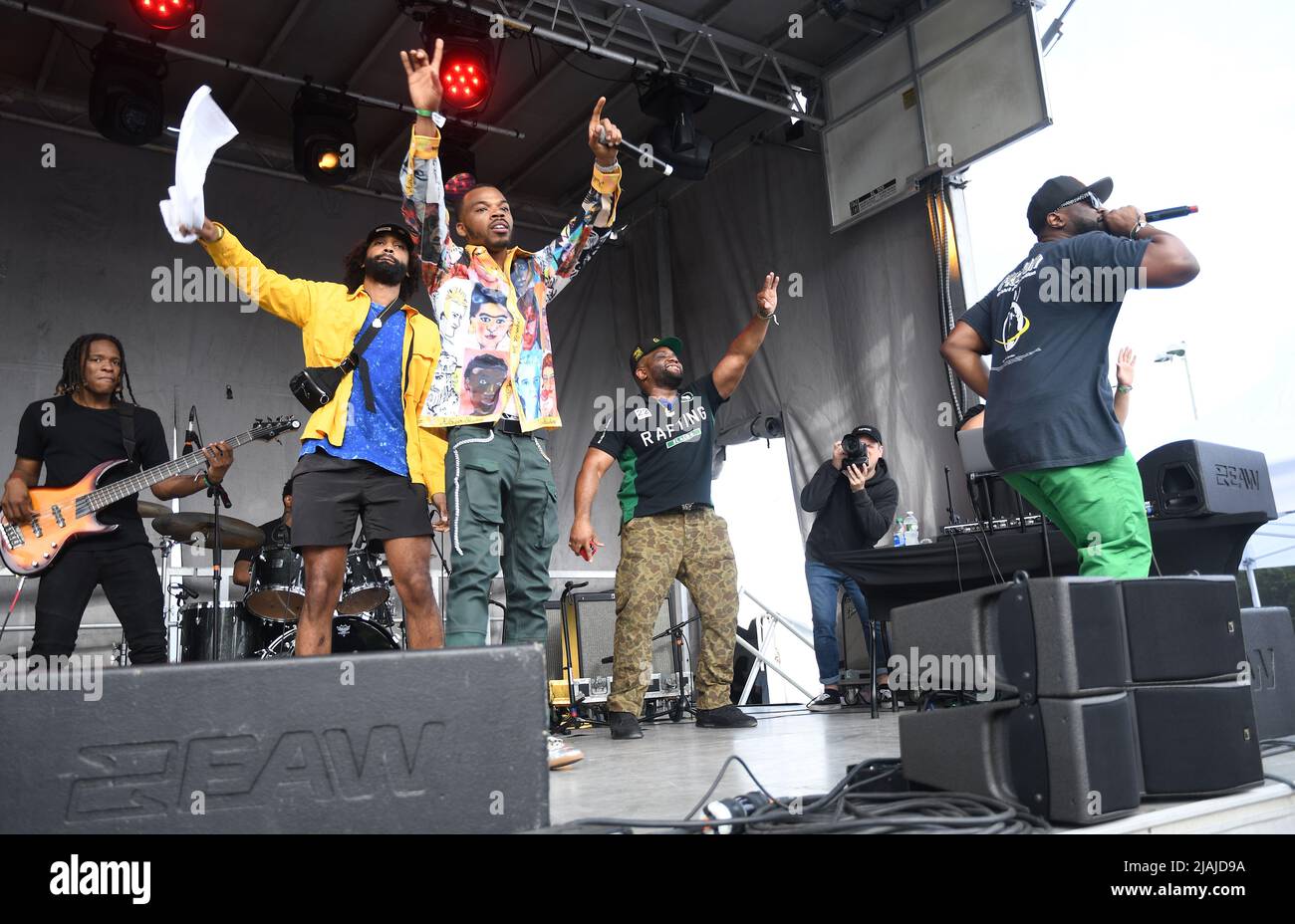 Rapper Avenue is shown performing on stage during a live concert ...