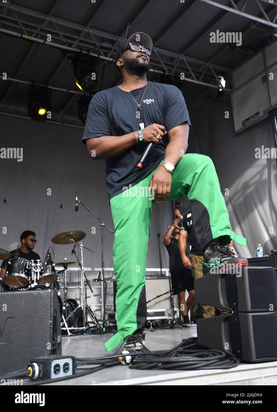 Rapper Avenue is shown performing on stage during a live concert ...