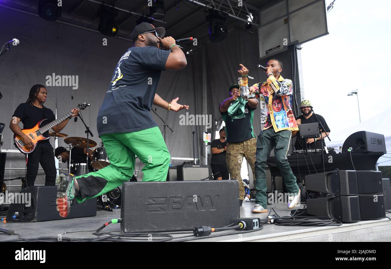 Rapper Avenue is shown performing on stage during a live concert ...