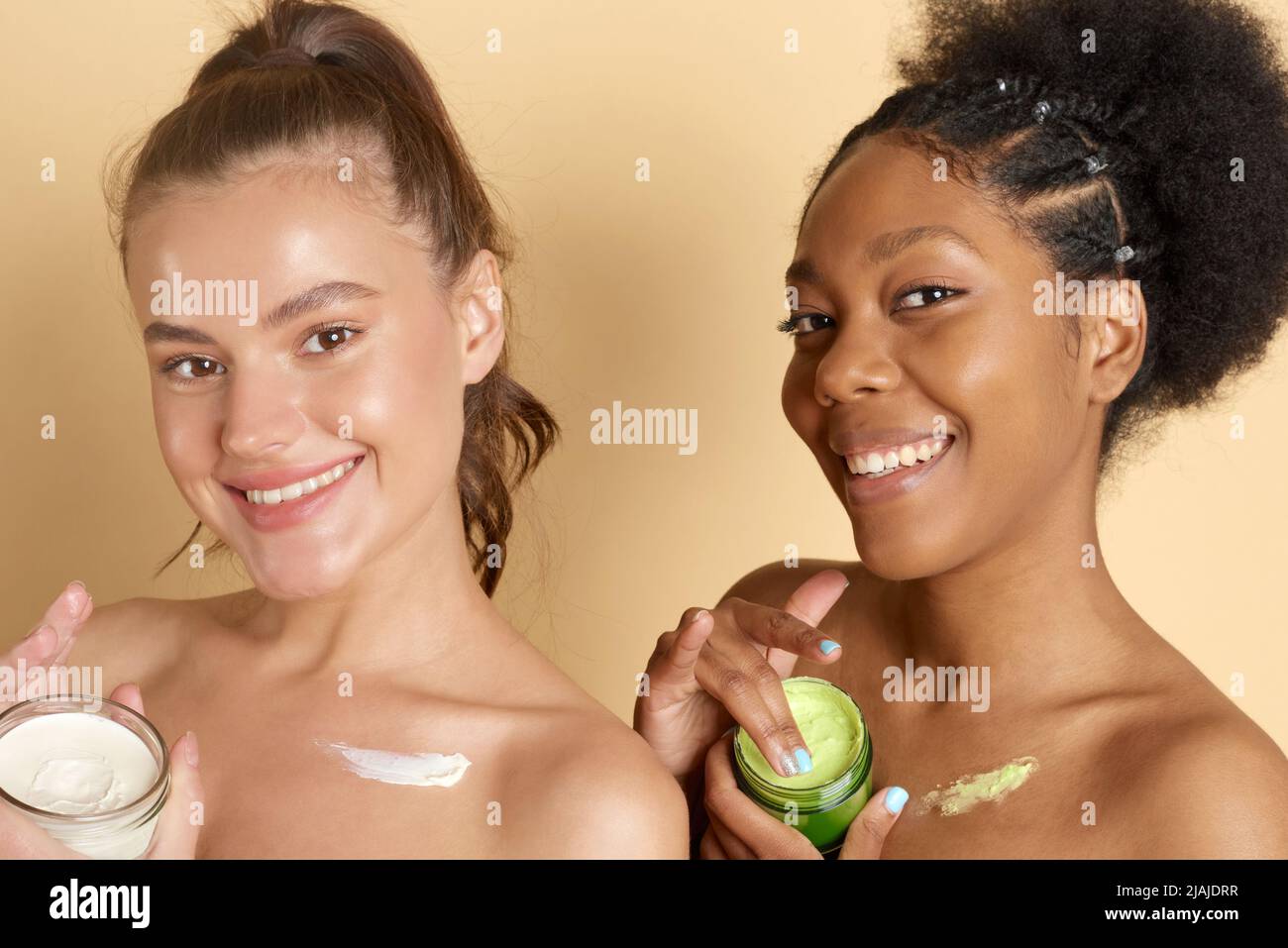 Smiling women hold jat of cosmetic moisturizer or face mask. Photo of ...