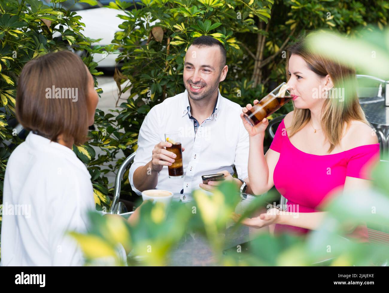 Man with two young women are talking about life and lunching Stock ...