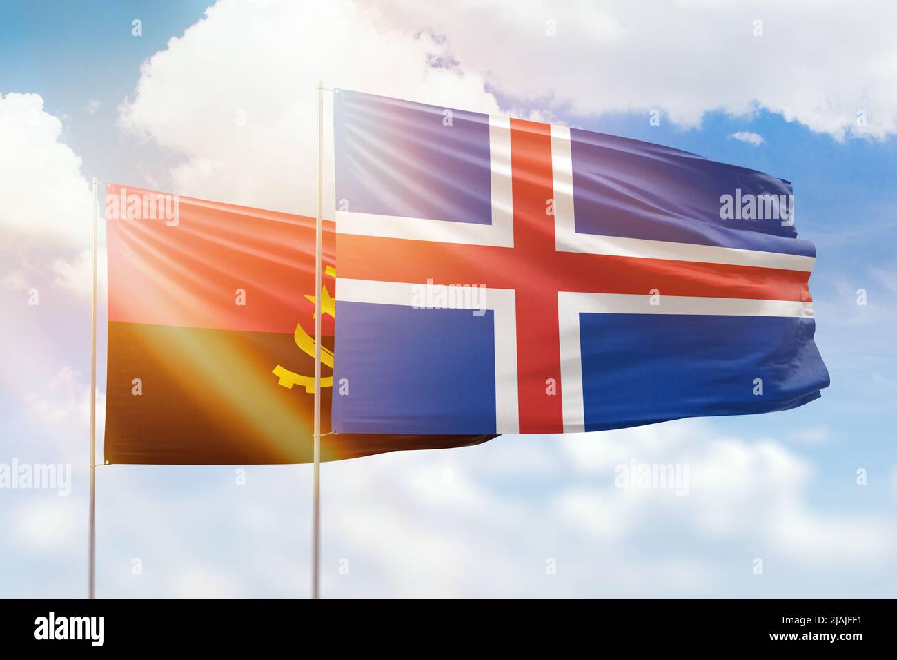 Sunny blue sky and flags of iceland and angola Stock Photo - Alamy