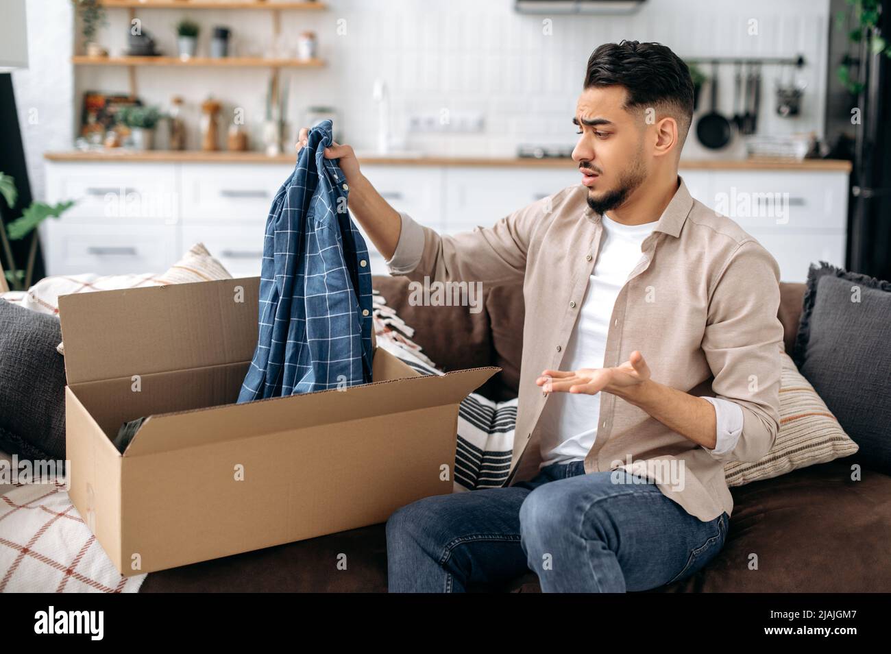 Unhappy customer opening box hi-res stock photography and images - Alamy