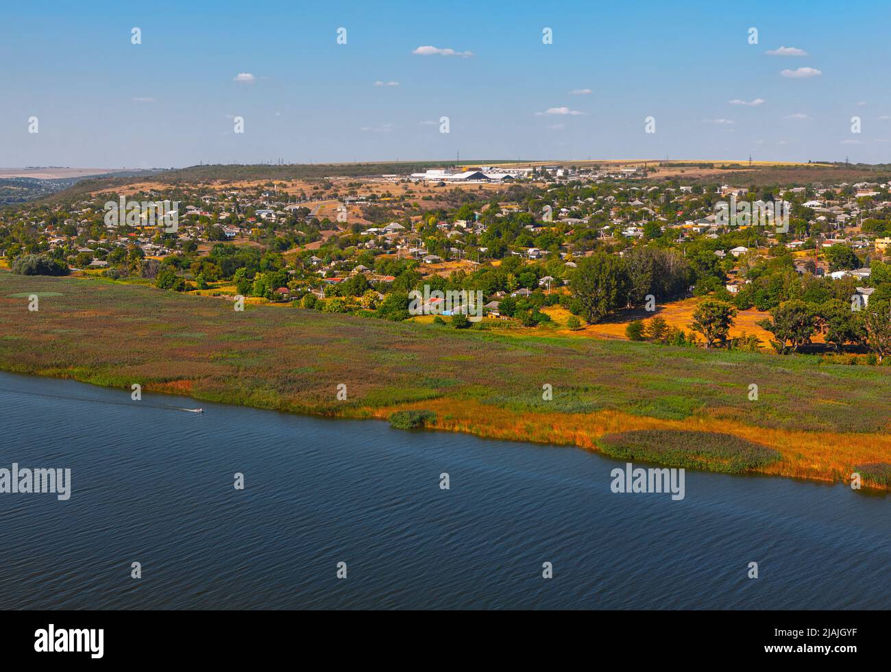 Countryside riverside . Rustic settlement panorama with river Stock ...