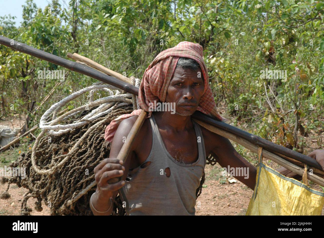 A tribal man returns from jungle during in a hunting festival in the ...