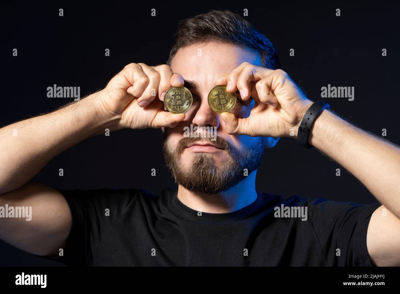 Happy bitcoin lover with golden coin by eyes. Digitall symbol of a new ...