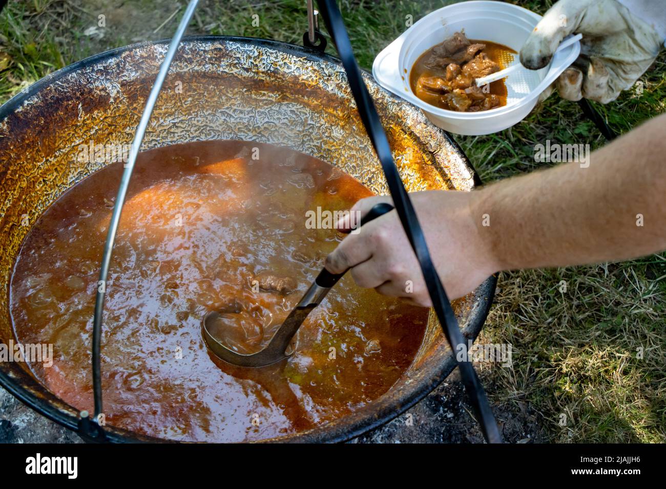 Cooking in a cauldron on an open fire in nature Stock Photo - Alamy