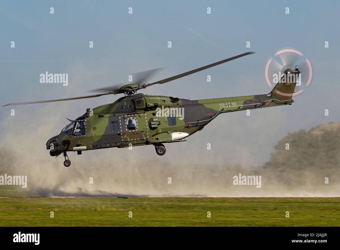 A German Army NH90 transport helicopter takes off from a remote field ...