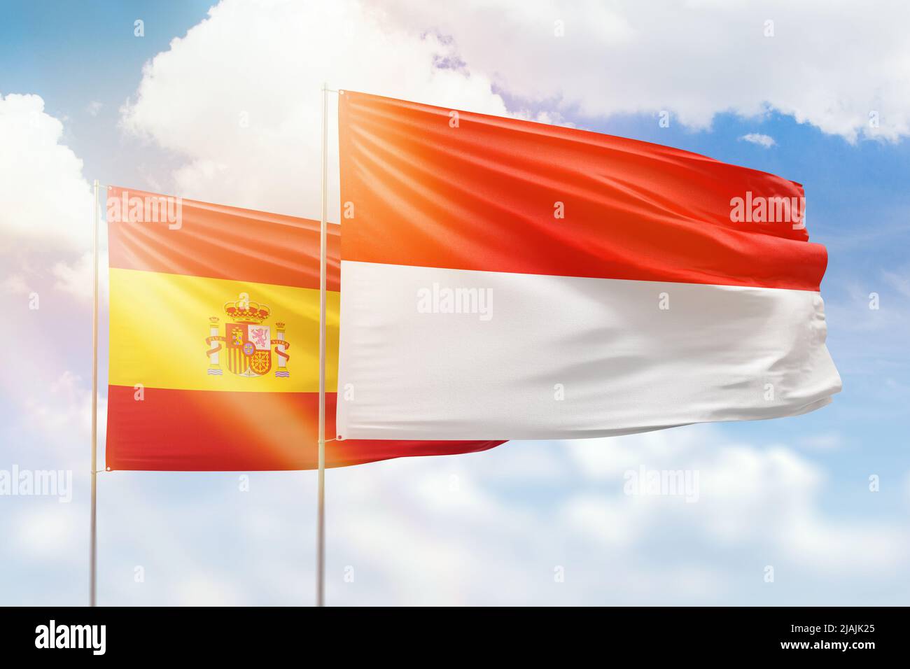 Sunny blue sky and flags of indonesia and spain Stock Photo - Alamy