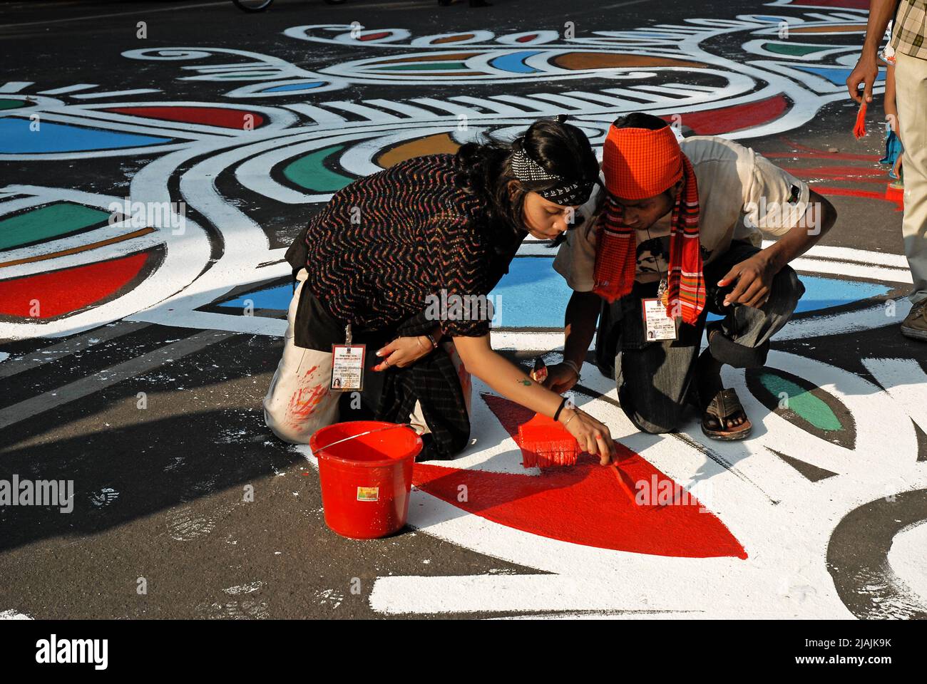 Students of the Institute of Fine Arts paint alpona (color designs) on ...