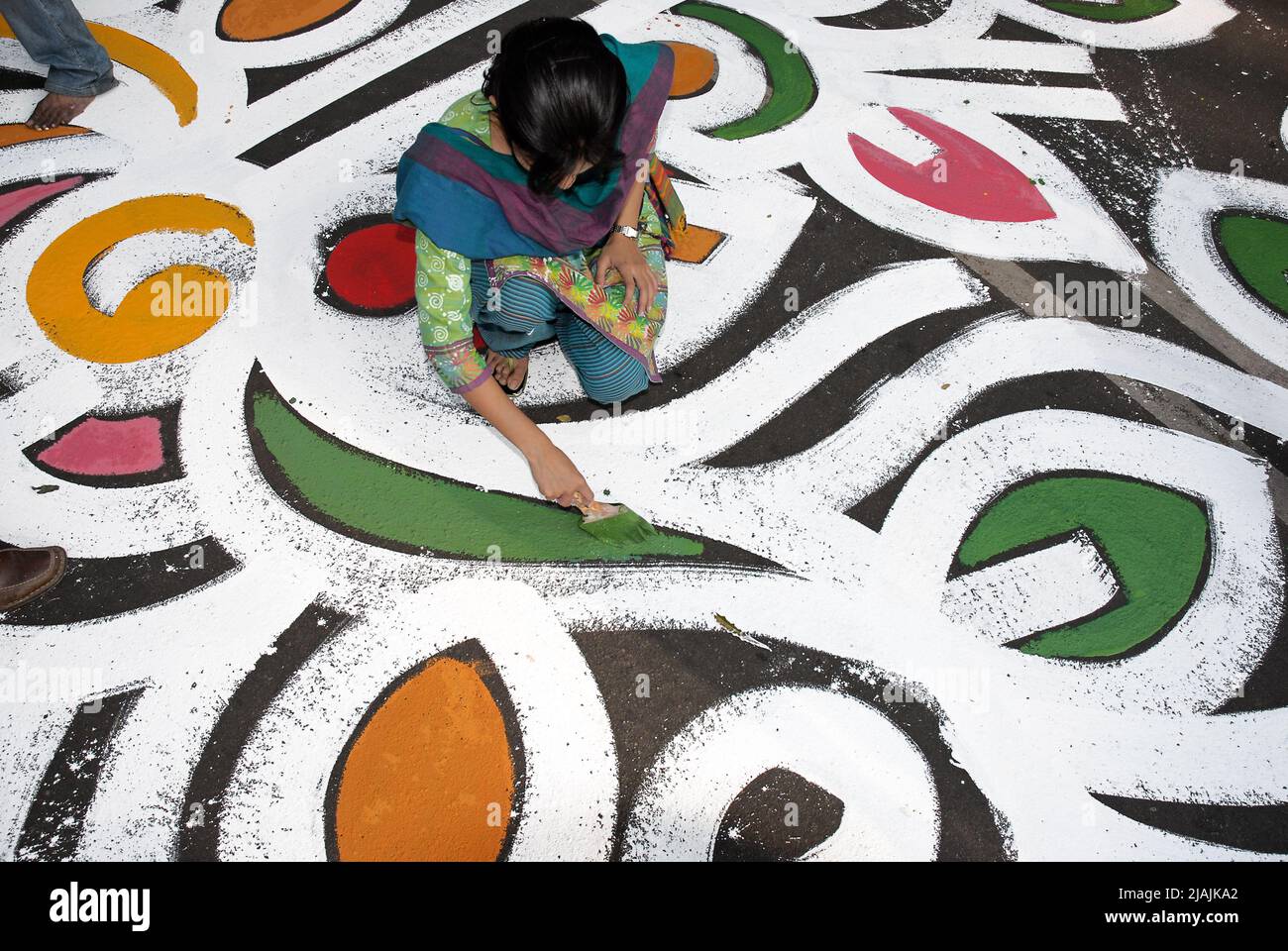 Students of the Institute of Fine Arts painting alpona (color designs ...