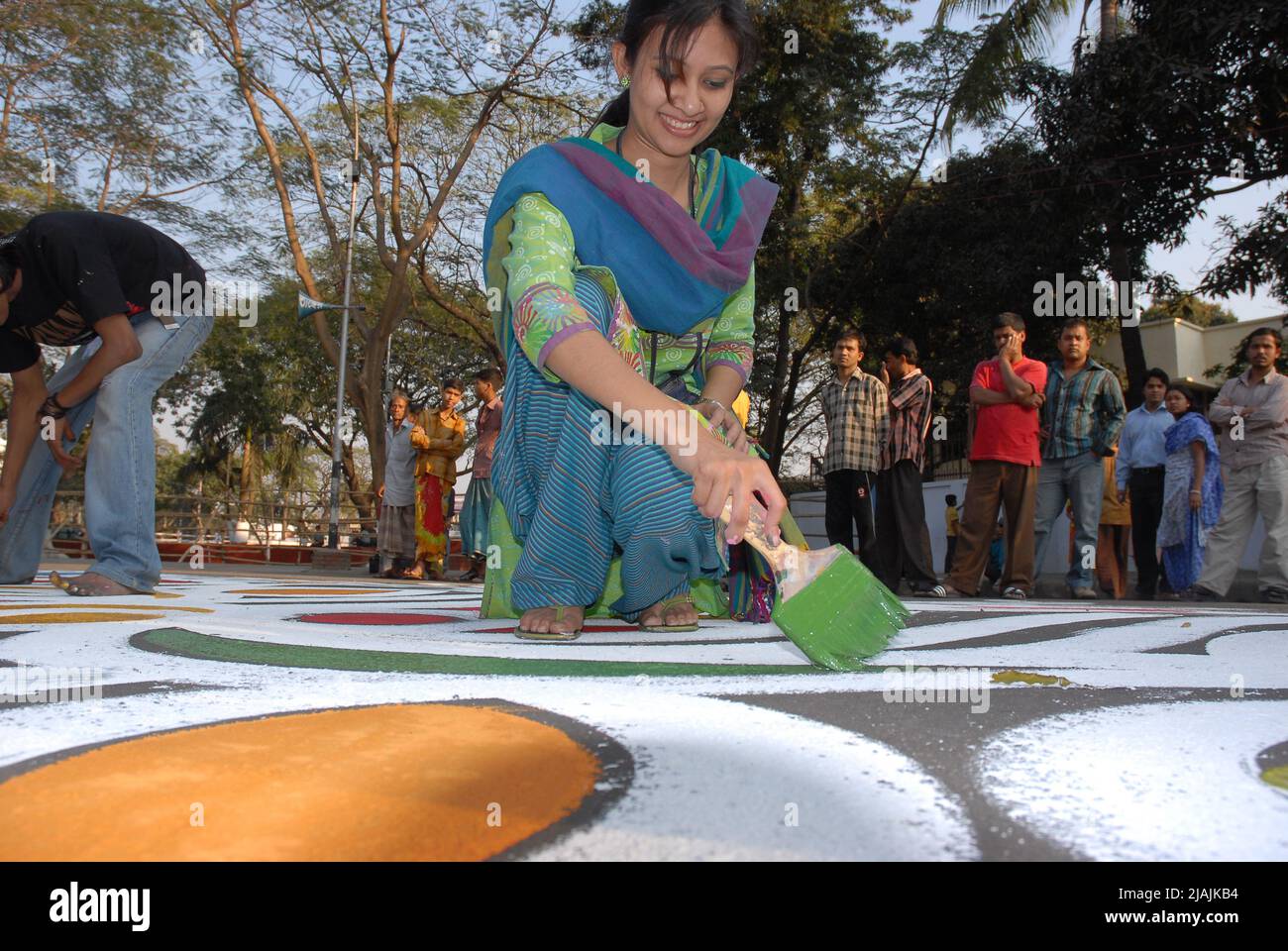 Students of the Institute of Fine Arts paint alpona (color designs) on ...